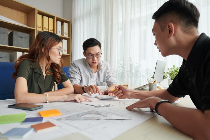 Engineers Discussing Cost Estimation Stock Photo - Image of teamwork ...
