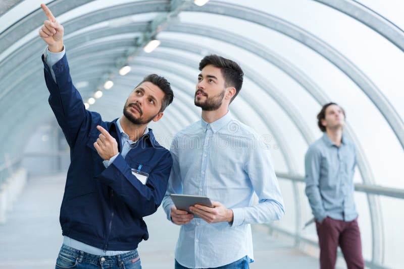 Two Engineers Discussing Work Together in Office Stock Image - Image of ...