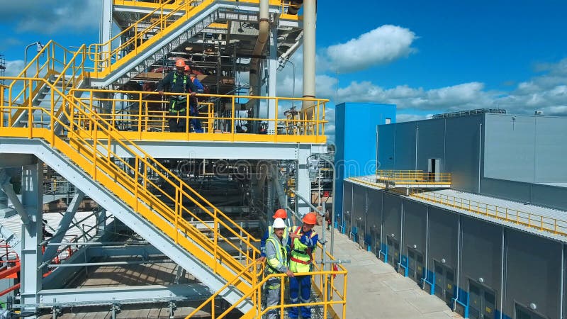 Engineers Discussing a New Project. Large Industry Background Stock ...