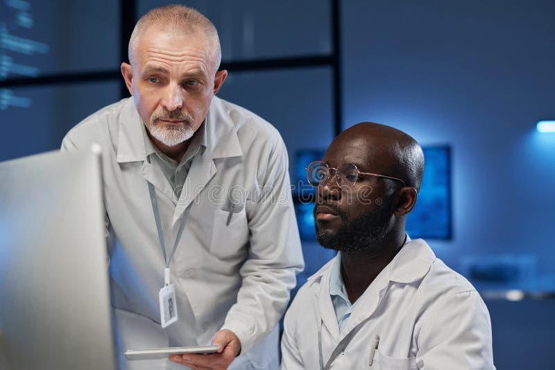 Engineers Discussing Program on Computer Stock Photo - Image of ...