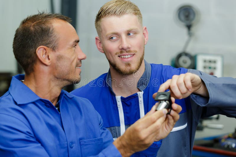 Engineers in Discussion while Holding Component Stock Image - Image of ...