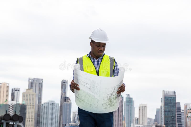 Engineers with Draft Plan of Building on Constructing Site. Engineer ...