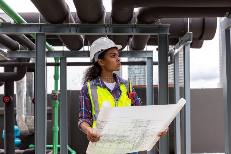 Engineers with Draft Plan of Building on Constructing Site. Engineer ...