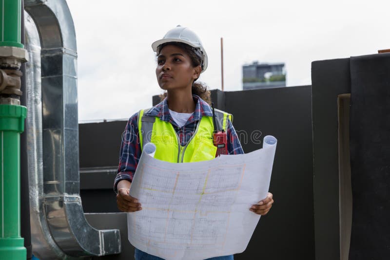 Engineers with Draft Plan of Building on Constructing Site. Engineer ...