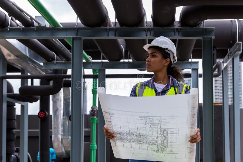 Engineers with Draft Plan of Building on Constructing Site. Engineer ...