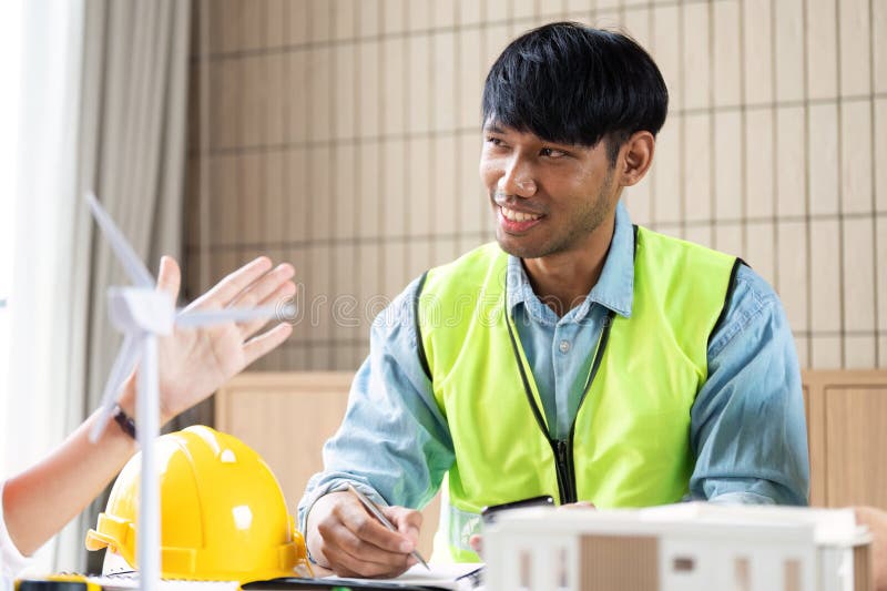 Sustainable Development Discussion. Engineers Collaborating on Renewable Energy Projects in a ...