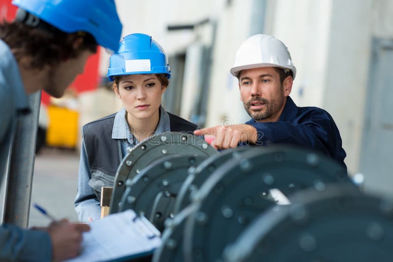 Engineers in a factory stock photo. Image of architect - 197179592