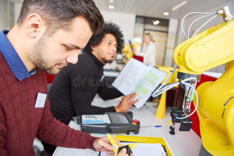 Engineers Programming Industrial Robots in a Training Lab Stock Photo ... Engineers Programming Industrial Robots in a Training Lab Stock Photo ...