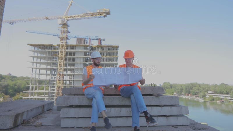 Engineers in Front of a Multi-storey Building. Two Engineers at a ...