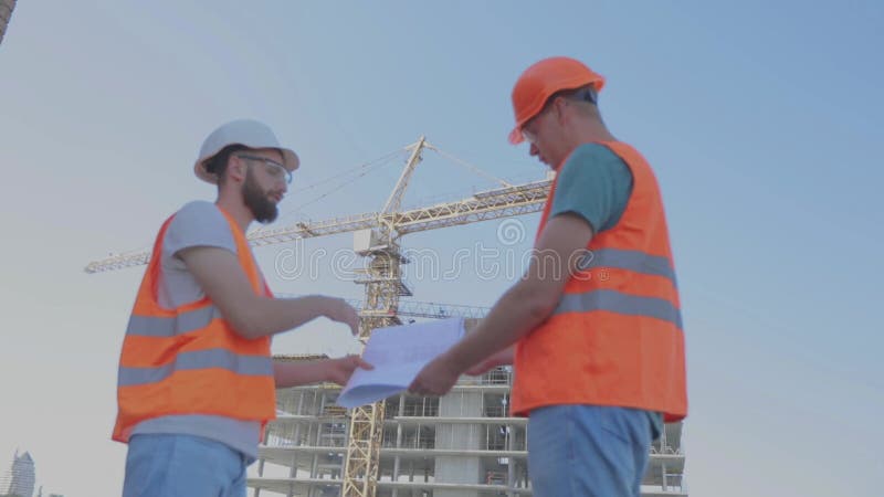 Engineers in Front of a Multi-storey Building. Two Engineers at a ...