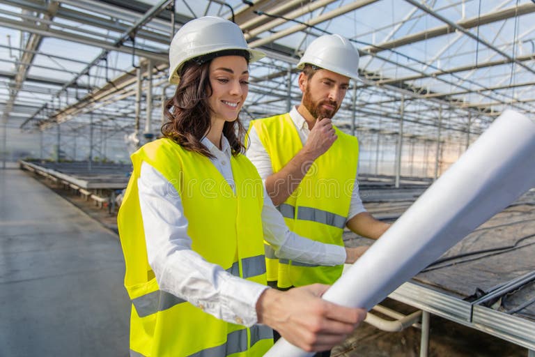 Engineers at the Greenhouse Construction Site Scrutinizing a ...