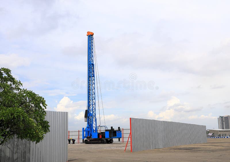 Engineers and Hammer Pile Driving Machine Working on Construction Area ...