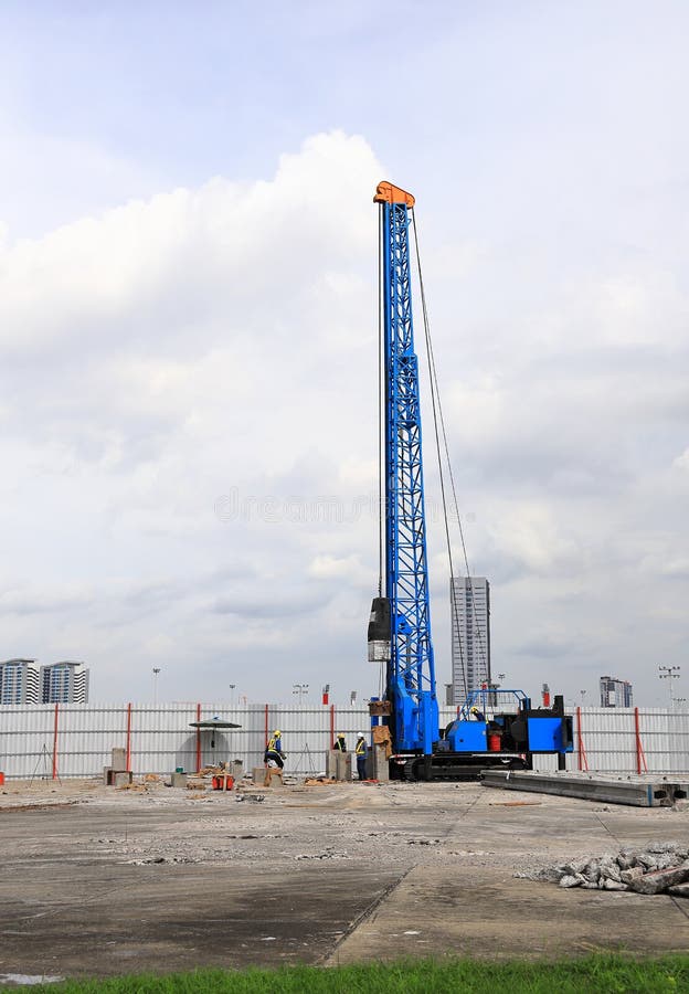 Engineers and Hammer Pile Driving Machine Working on Construction Area ...
