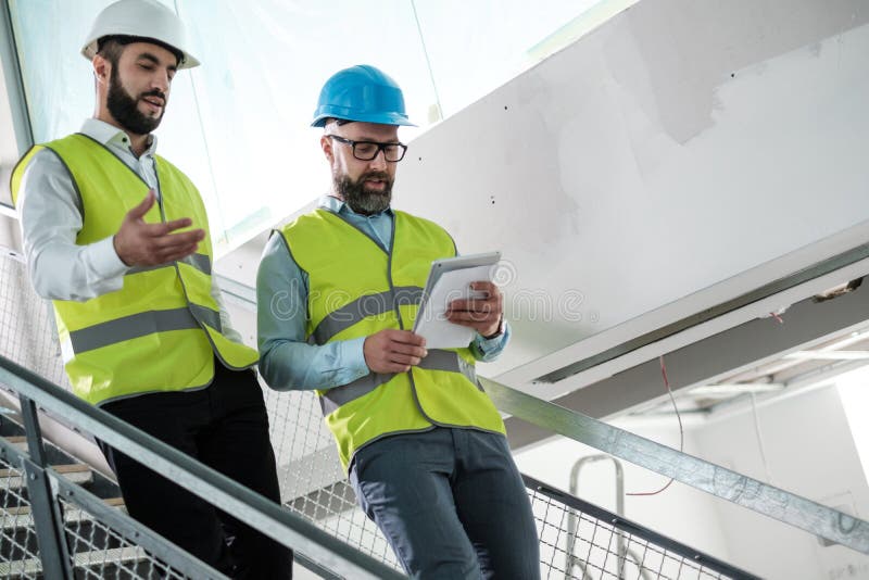 Engineers in Hardhats Having Conversation Stock Image - Image of ...