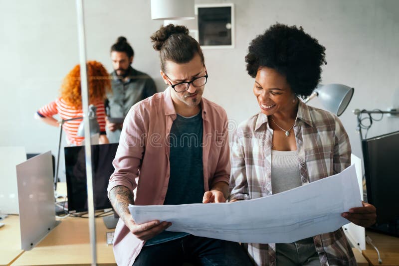 Engineers Helping Design Work on Blueprints, Collaborate on Structural ...