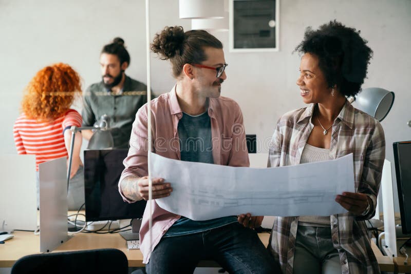 Engineers Helping Design Work on Blueprints, Collaborate on Structural ...