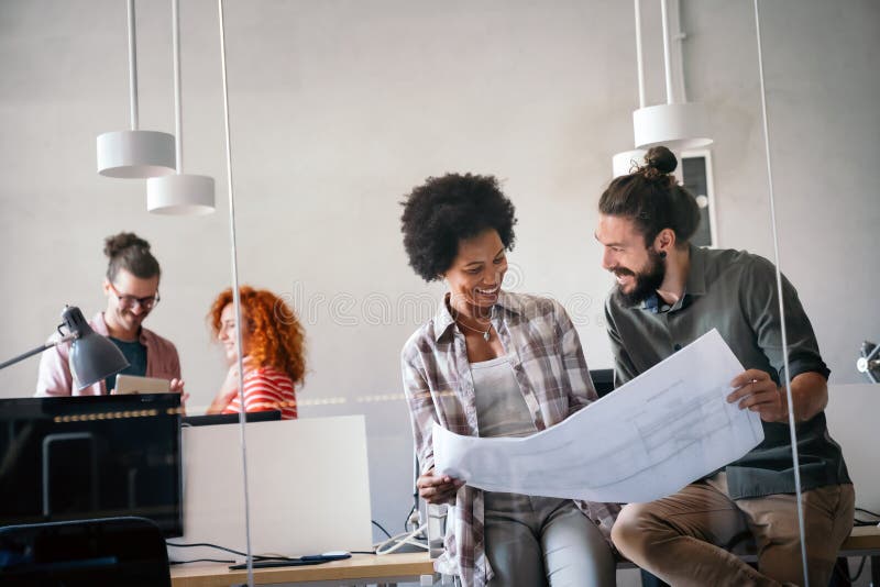 Engineers Helping Design Work on Blueprints, Collaborate on Structural ...