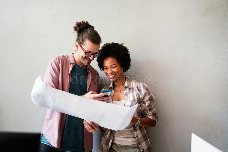 Engineers Helping Design Work on Blueprints, Collaborate on Structural ...
