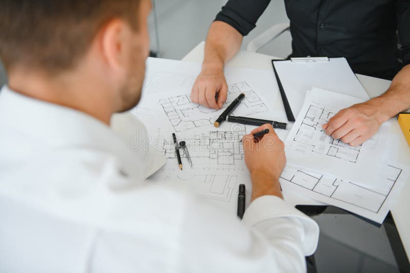 Engineers are Helping To Design Work on Blueprints and Collaborate on ...