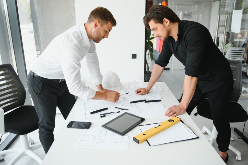 Engineers are Helping To Design Work on Blueprints and Collaborate on ...