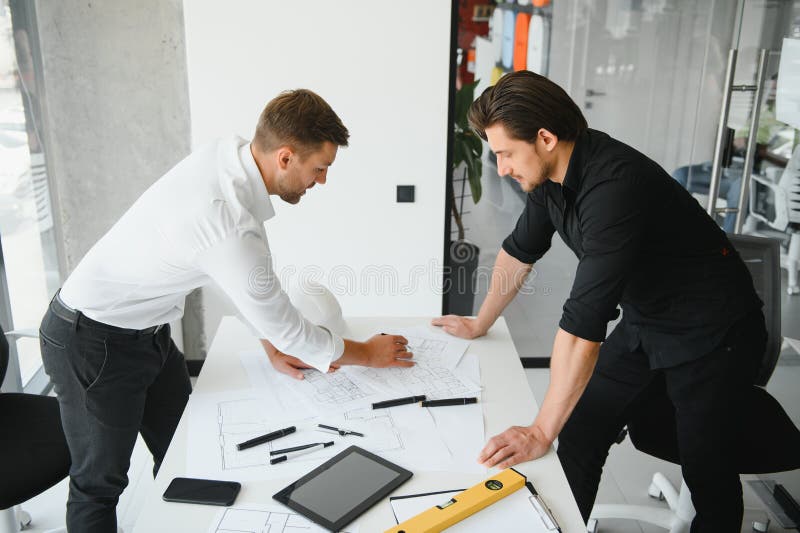 Engineers are Helping To Design Work on Blueprints and Collaborate on ...