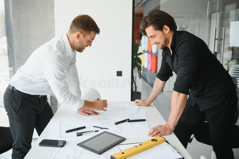 Engineers are Helping To Design Work on Blueprints and Collaborate on ...