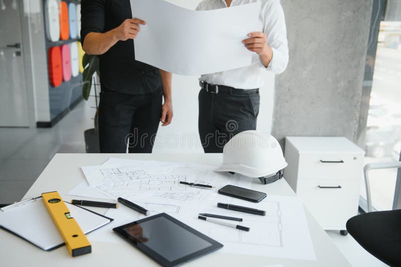 Engineers are Helping To Design Work on Blueprints and Collaborate on ...