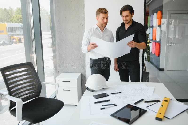 Engineers are Helping To Design Work on Blueprints and Collaborate on ...