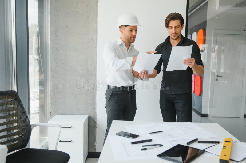 Engineers are Helping To Design Work on Blueprints and Collaborate on ...