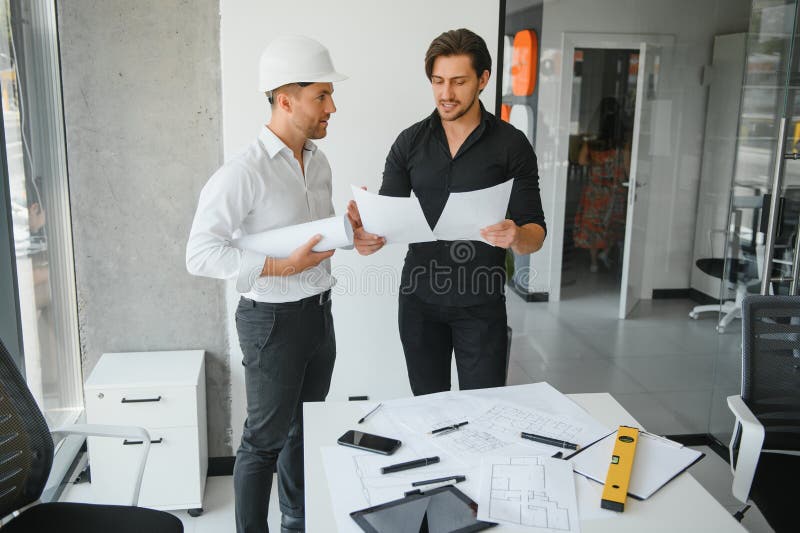 Engineers are Helping To Design Work on Blueprints and Collaborate on ...