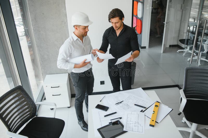 Engineers are Helping To Design Work on Blueprints and Collaborate on ...