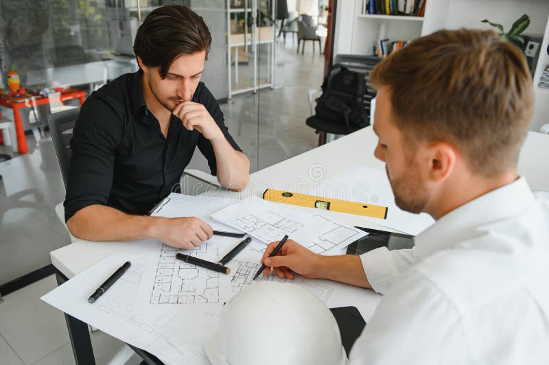 Engineers are Helping To Design Work on Blueprints and Collaborate on ...