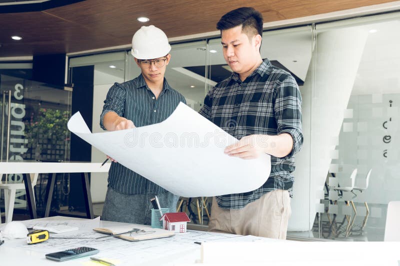 Engineers are Helping To Design Work on Blueprints and Collaborate on ...