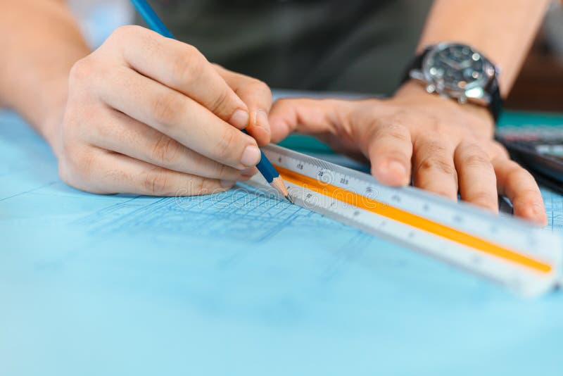 Engineers Holding a Pen Pointing To a Building and Drawing Outlay ...