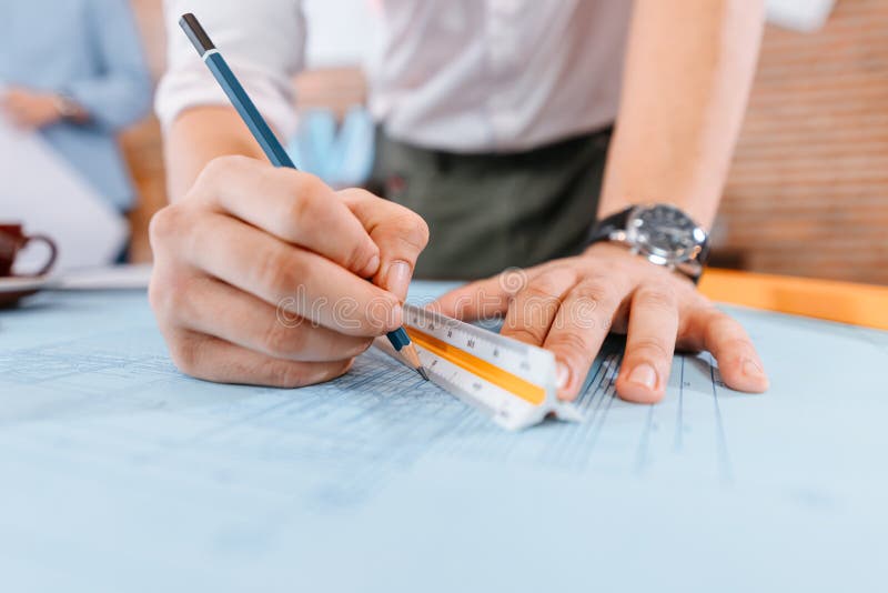 Engineers Holding a Pen Pointing To a Building and Drawing Outlay ...