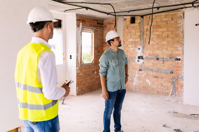 Engineers Inspecting Construction Site Progress and Planning Next Steps ...