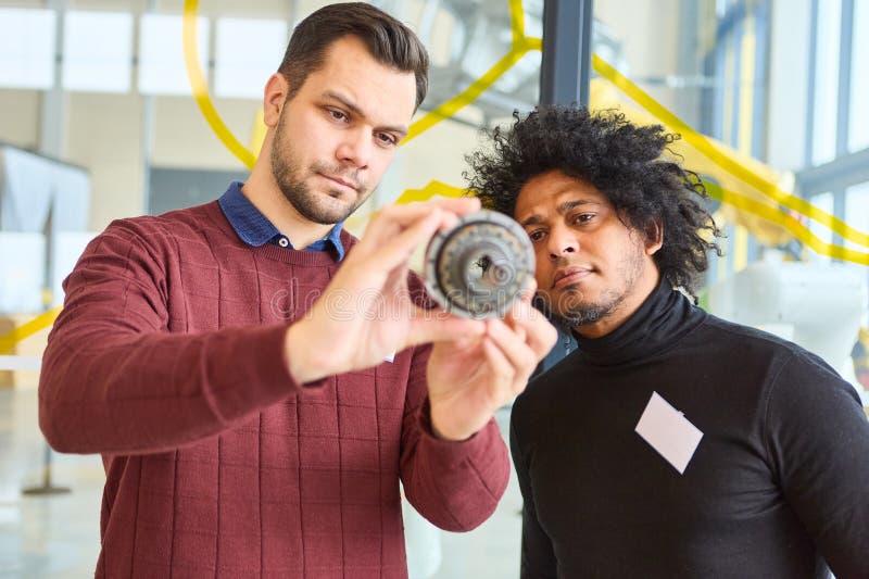 Engineers Inspecting a Mechanical Component for Robotics and Automation ...
