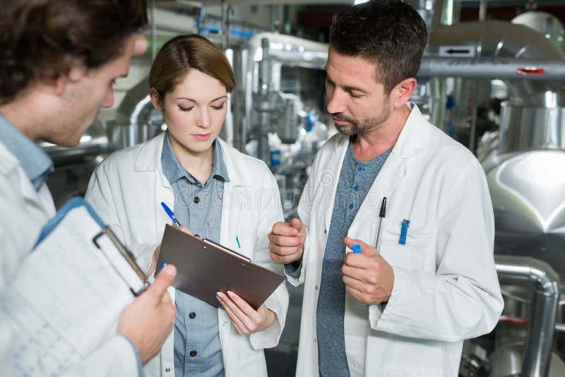 Engineers in Lab Coats Working in Factory Stock Image - Image of ...