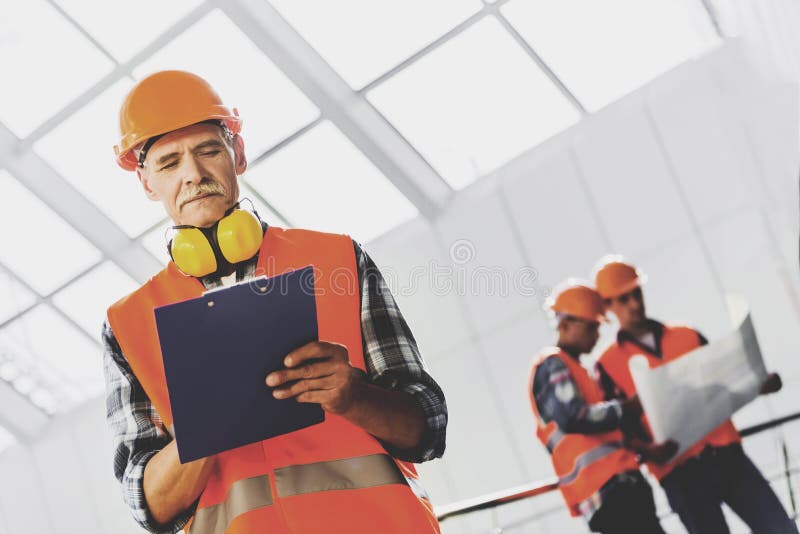 Engineers Makes Notes and Works with Blueprint. Stock Image - Image of ...