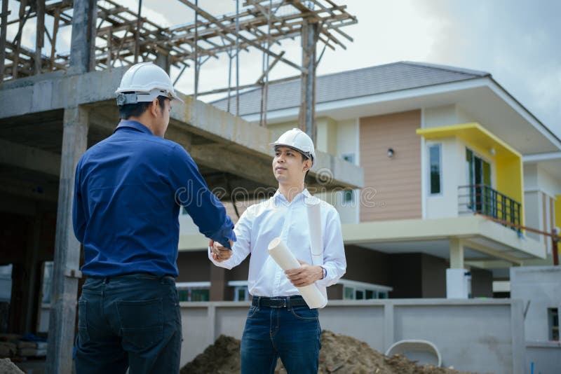 Engineers Man Handshake at Construction Site. Worker and Contruction ...