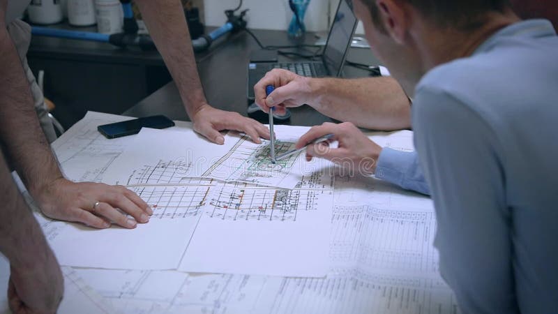 Engineers and Managers in the Conference Room Discuss Drawings and ...