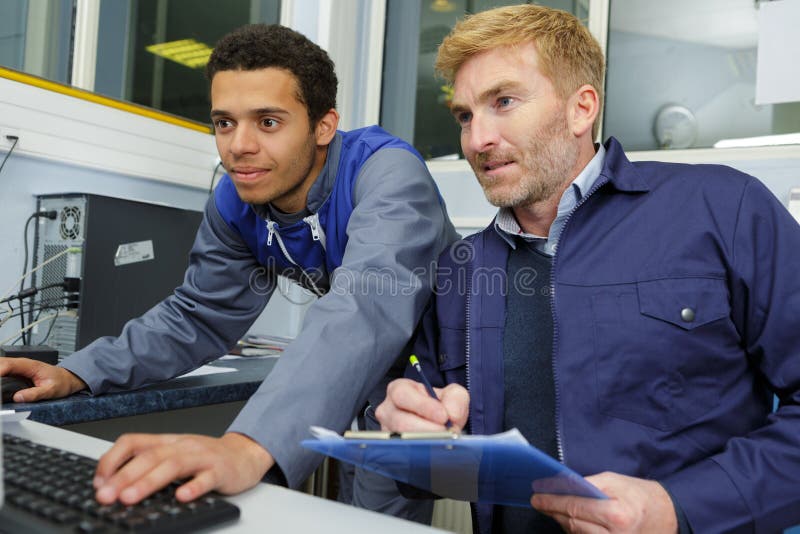 Engineers in Mechanical Office Reading Instructions Stock Image - Image ...