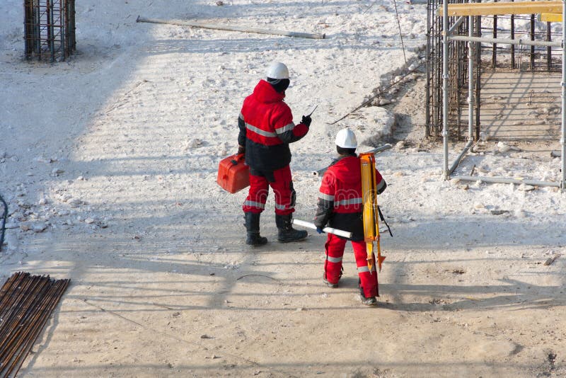 Engineers in Red Dress with a Tool on Construction Stock Image - Image ...