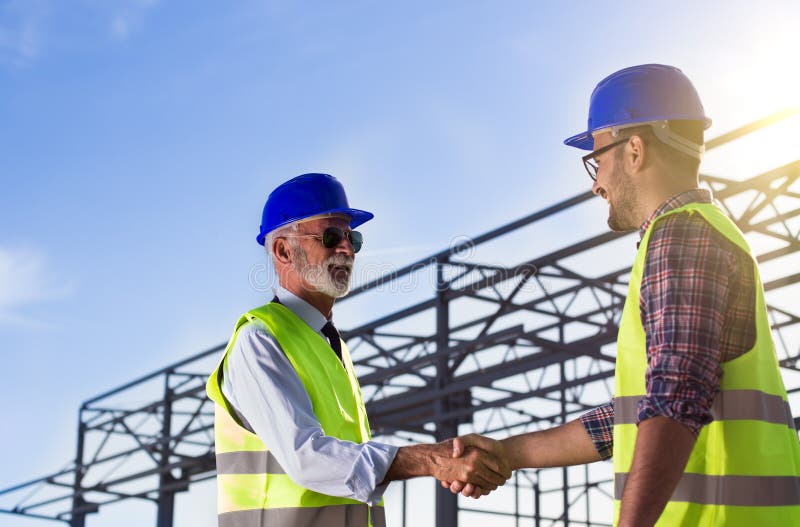 Engineers Shaking Hands on Construction Site Stock Photo - Image of ...