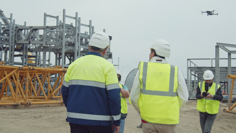 Engineers and Shooting Crew with Drone at Construction Site Stock ...