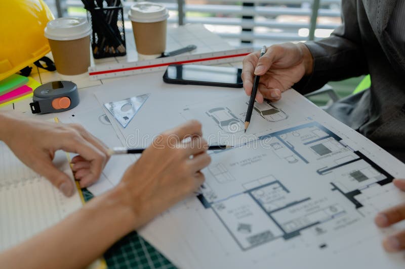 Engineers are Sitting Discussing a Construction Plan that Needs To Be ...