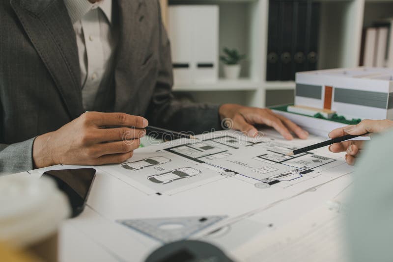 Engineers are Sitting Discussing a Construction Plan that Needs To Be ...