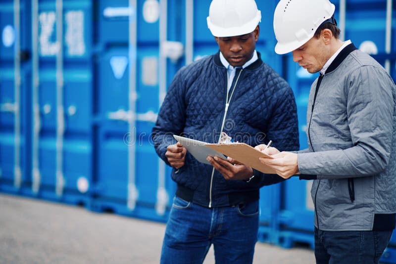 Engineers Standing in a Shipping Yard Tracking Freight Inventory Stock ...