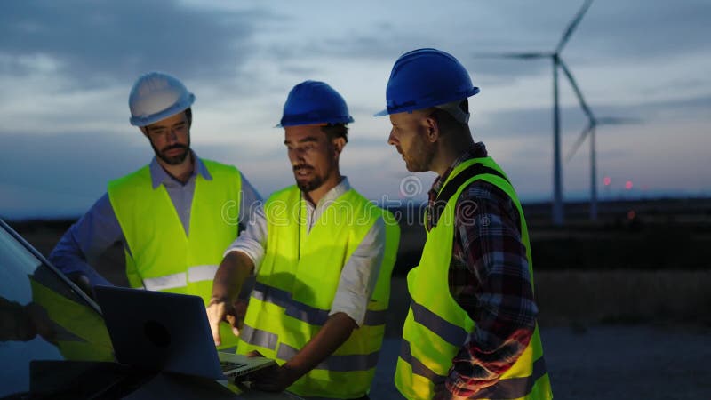 Engineers Teamwork Discussing Renewable Energy Project at Wind Turbine ...