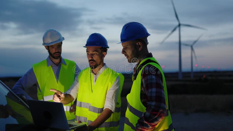 Engineers Teamwork Discussing Renewable Energy Project at Wind Turbine ...